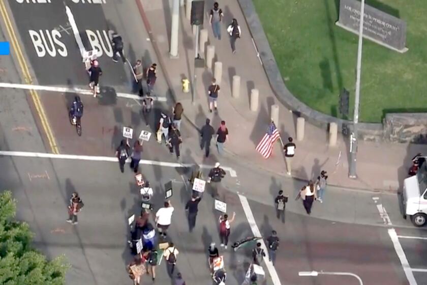Anti-Trump protesters join 'Free America' walkout in downtown LA and ...