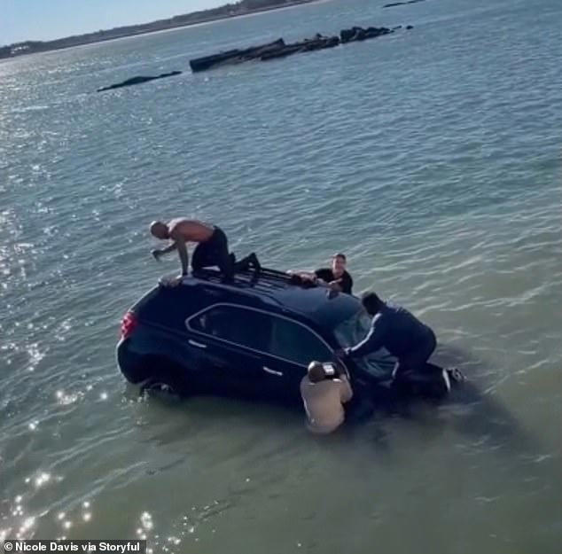 Heroes pull woman from sinking SUV after doors jam shut in dramatic rescue