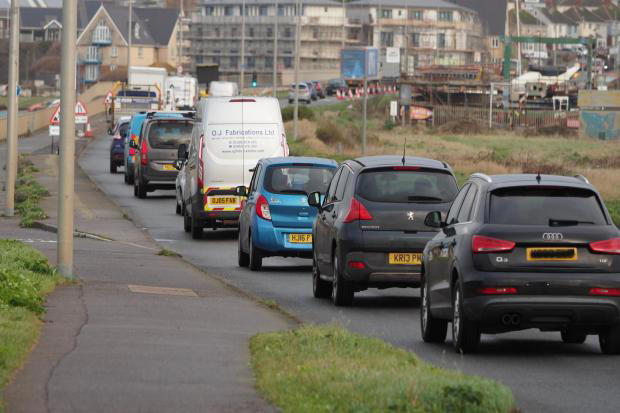 Traffic lights removed from beach road as weather delays works