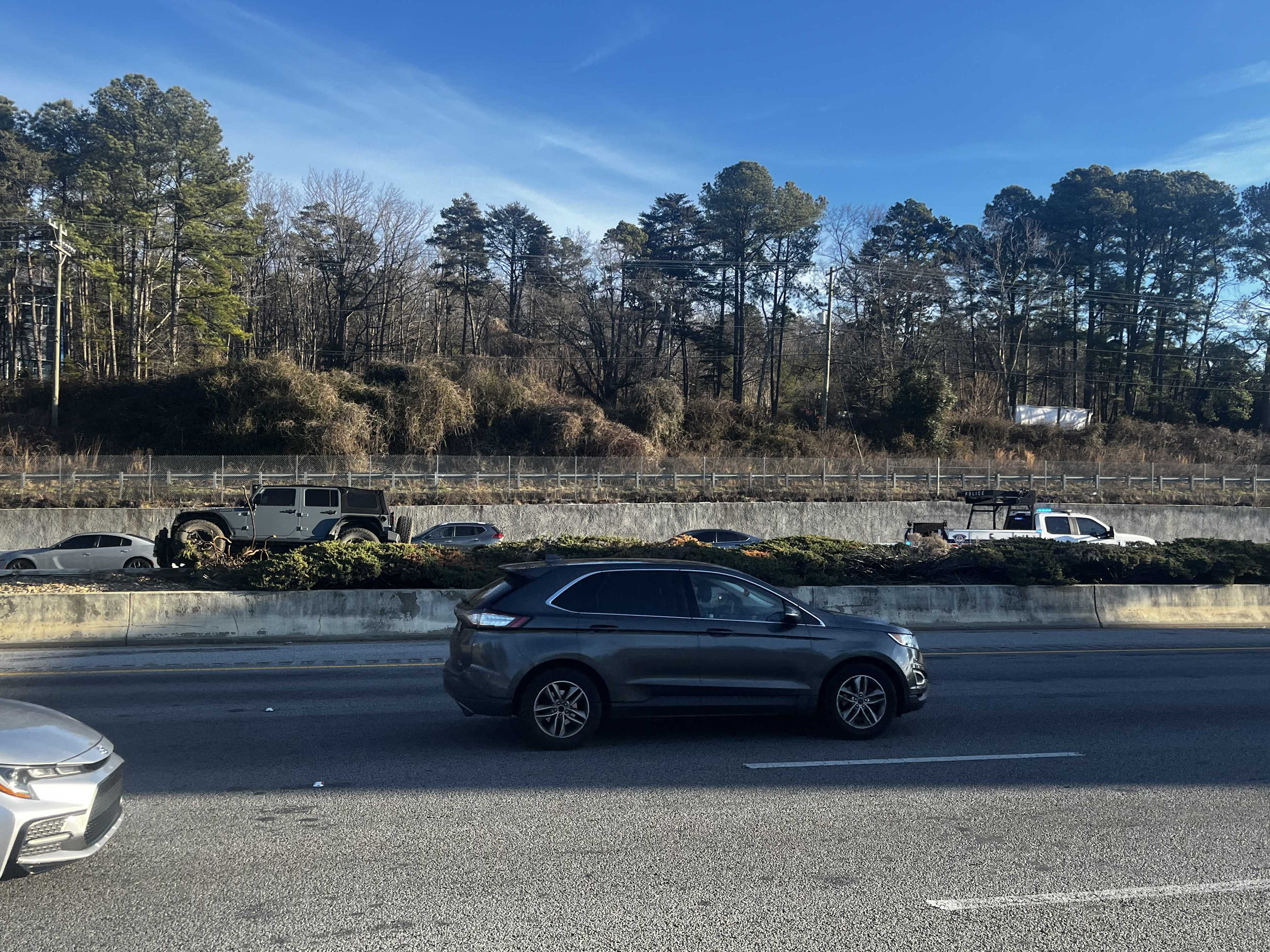 Vehicle lands on concrete barrier in middle on I-385