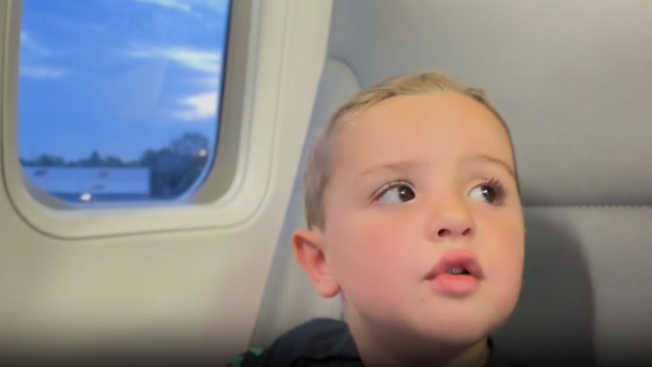 Boy's excitement encounters turbulence as the plane gets ready for takeoff!