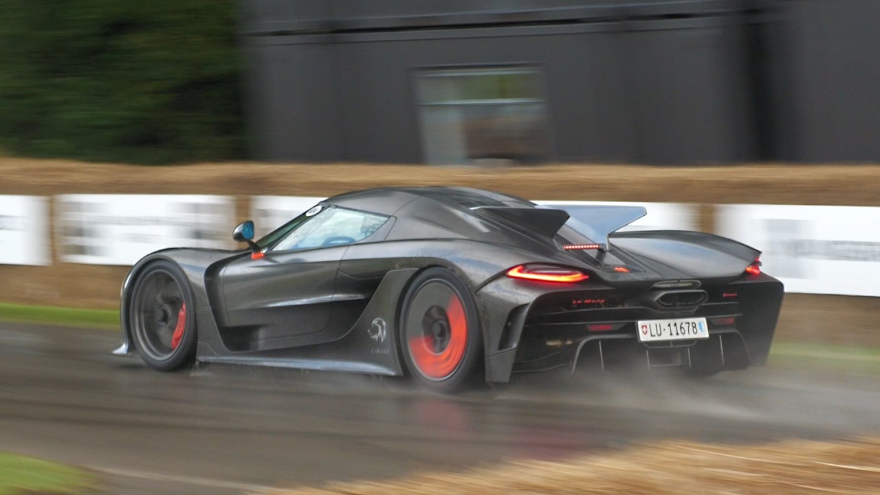 Luxury performance cars accelerate on rain-soaked roads