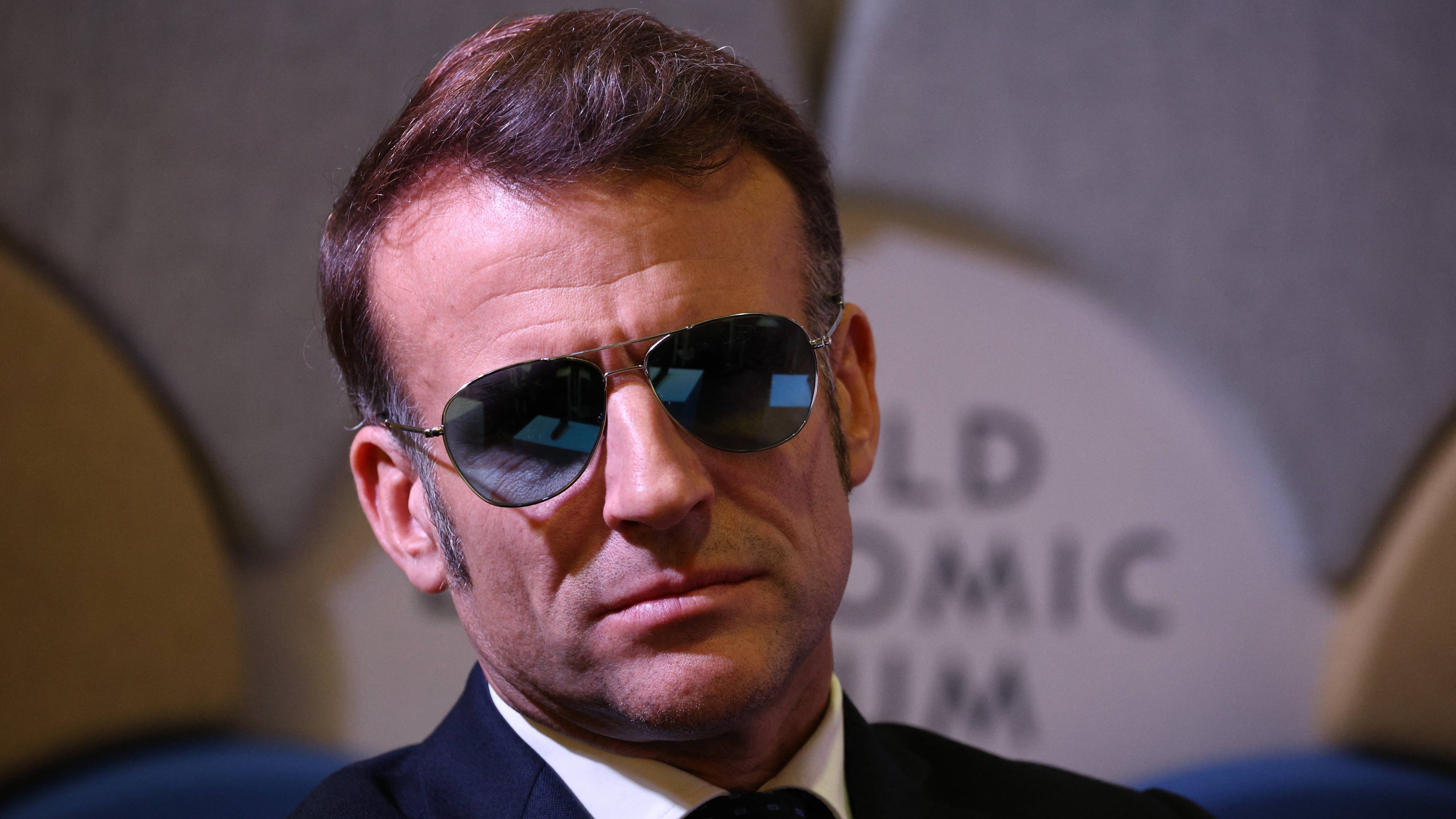 Why was Macron wearing sunglasses indoors at Davos?