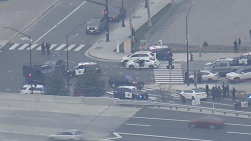 San Jose police say an officer was shot following a carjacking