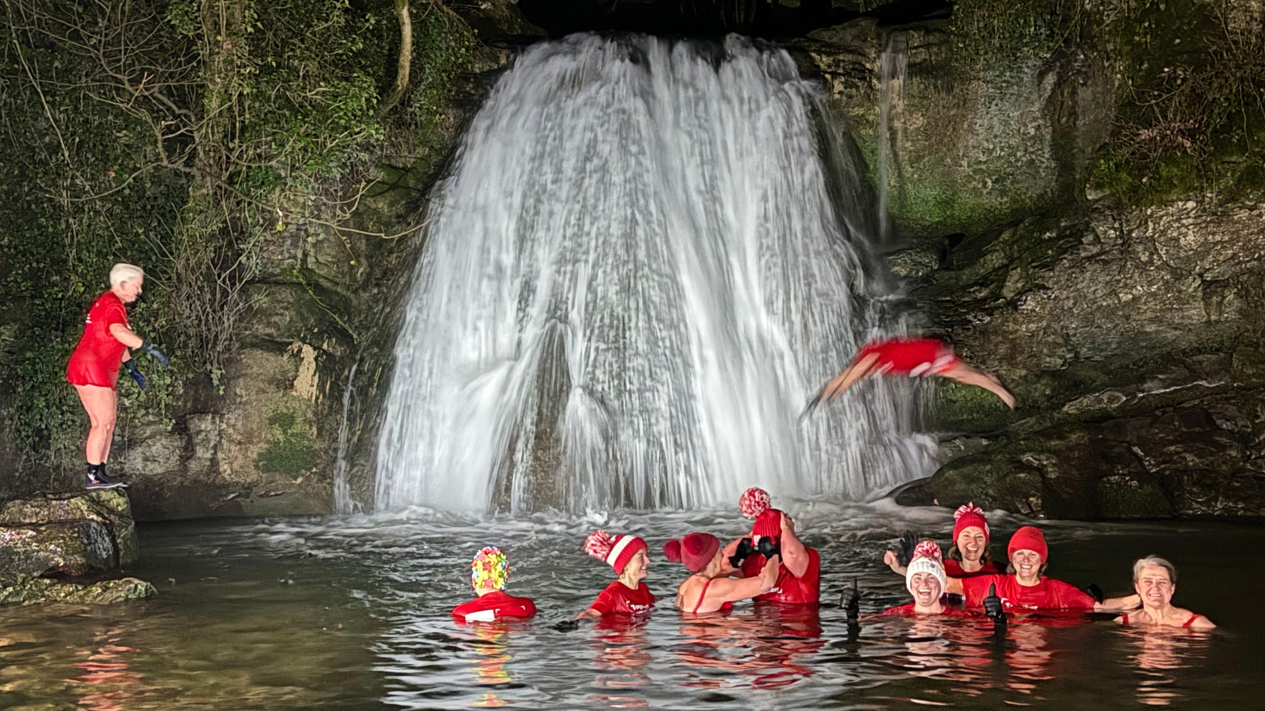 Night dip at waterfall raises money for homeless