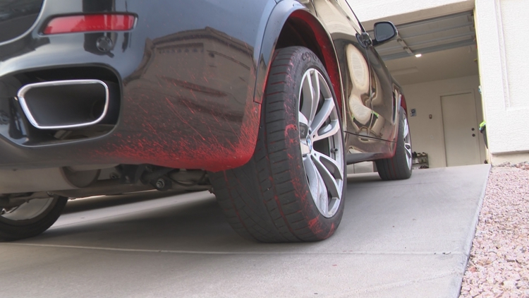 Wet, red paint spilled on roadway damages Arizona woman's car