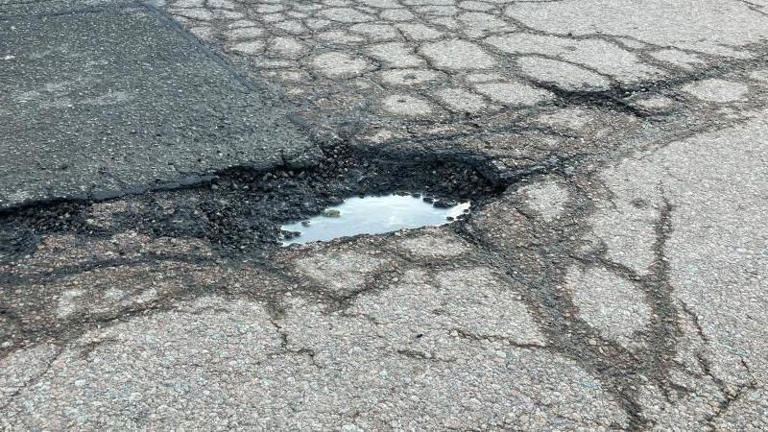 Potholed road compared to 'patchwork quilt'