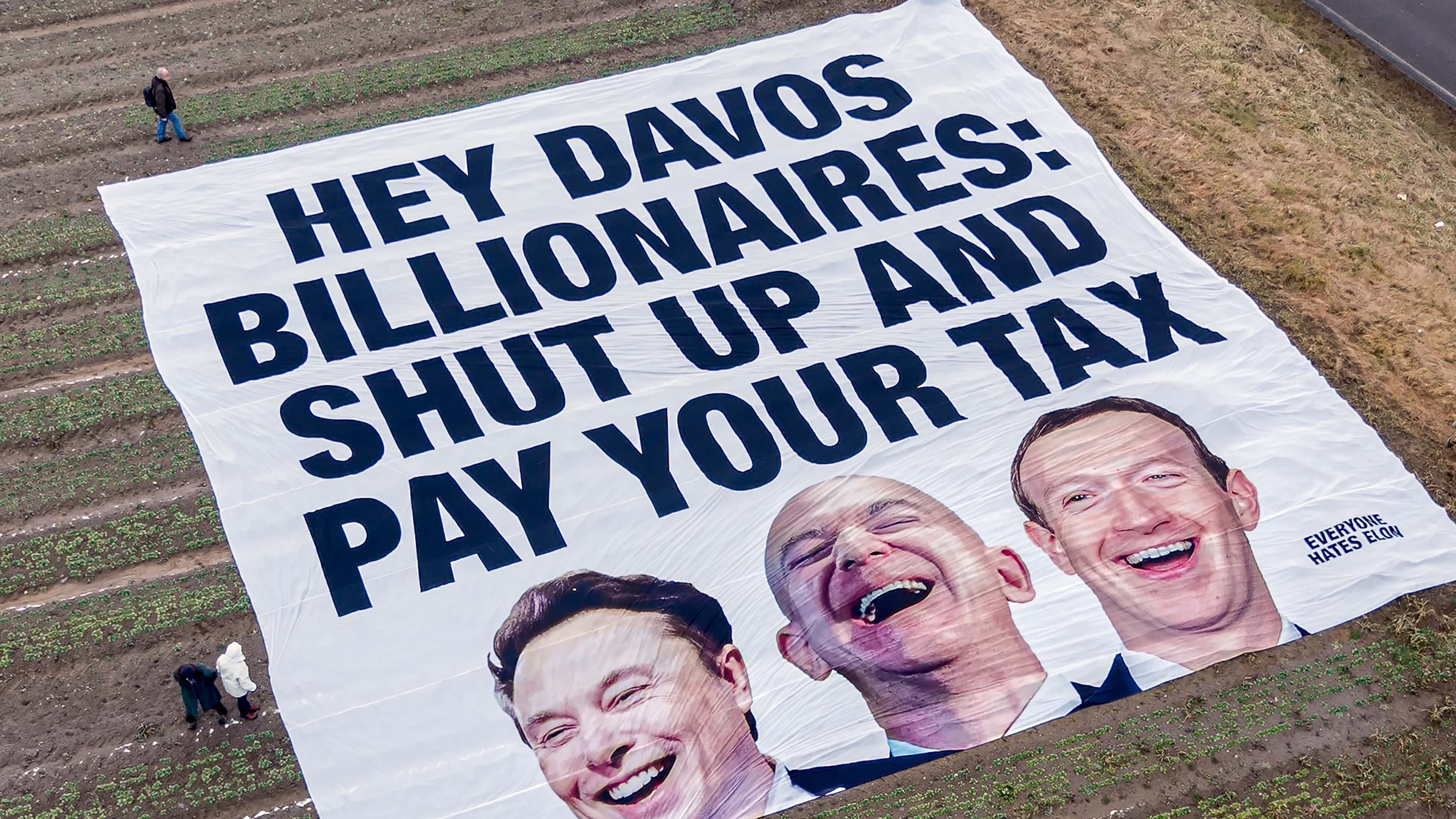 Giant banner urging billionaires Elon Musk and Jeff Bezos to "shut up ...