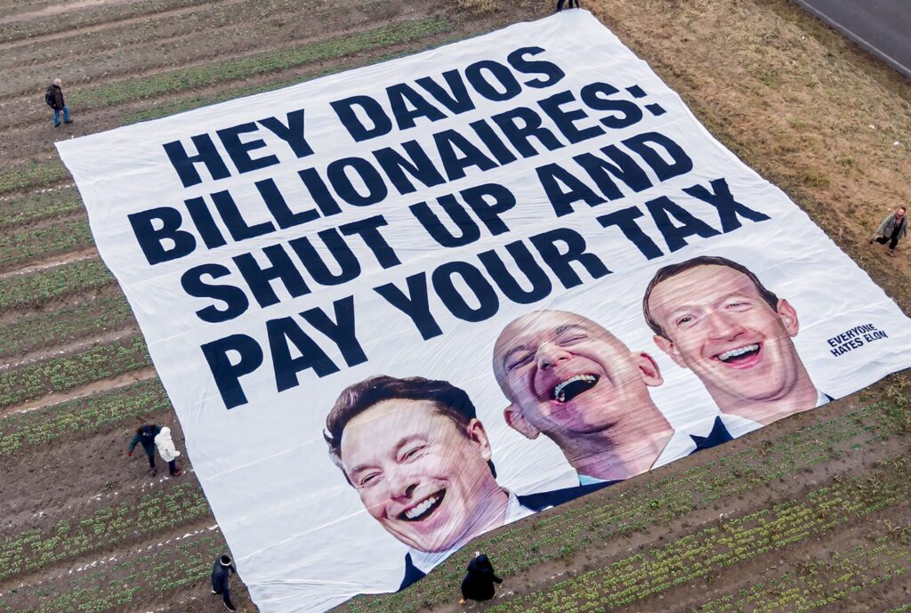 Giant banner urging billionaires Elon Musk and Jeff Bezos to “shut up ...