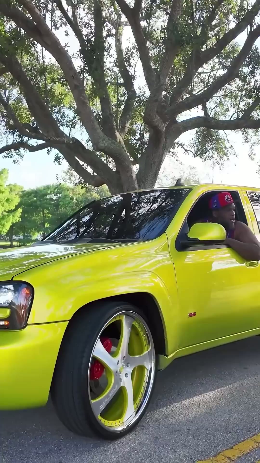 Candy lime gold Chevy Trailblazer on 26’s Forgiatos at the Easter carshow