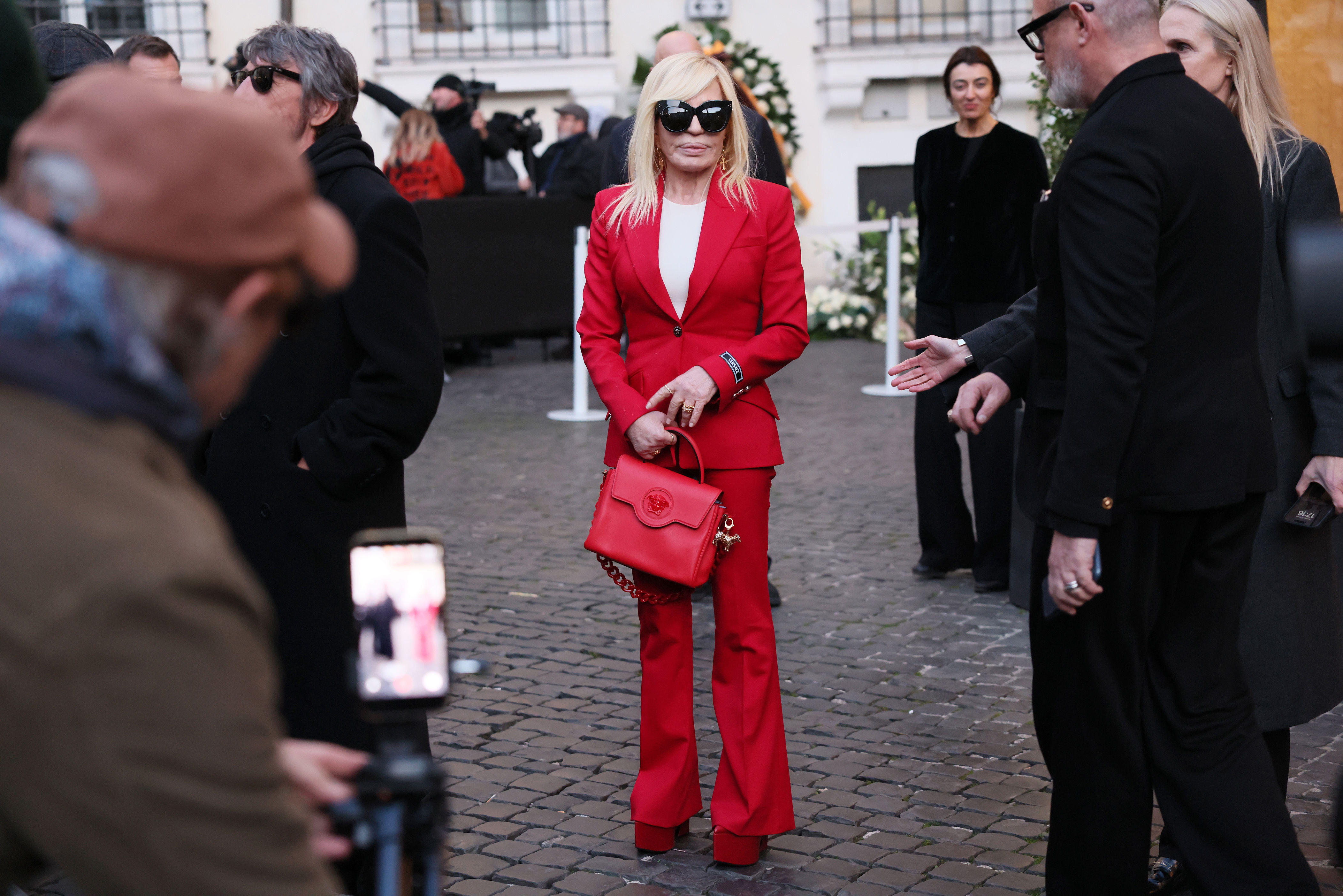 Donatella Versace honors the late Valentino in his signature red hue