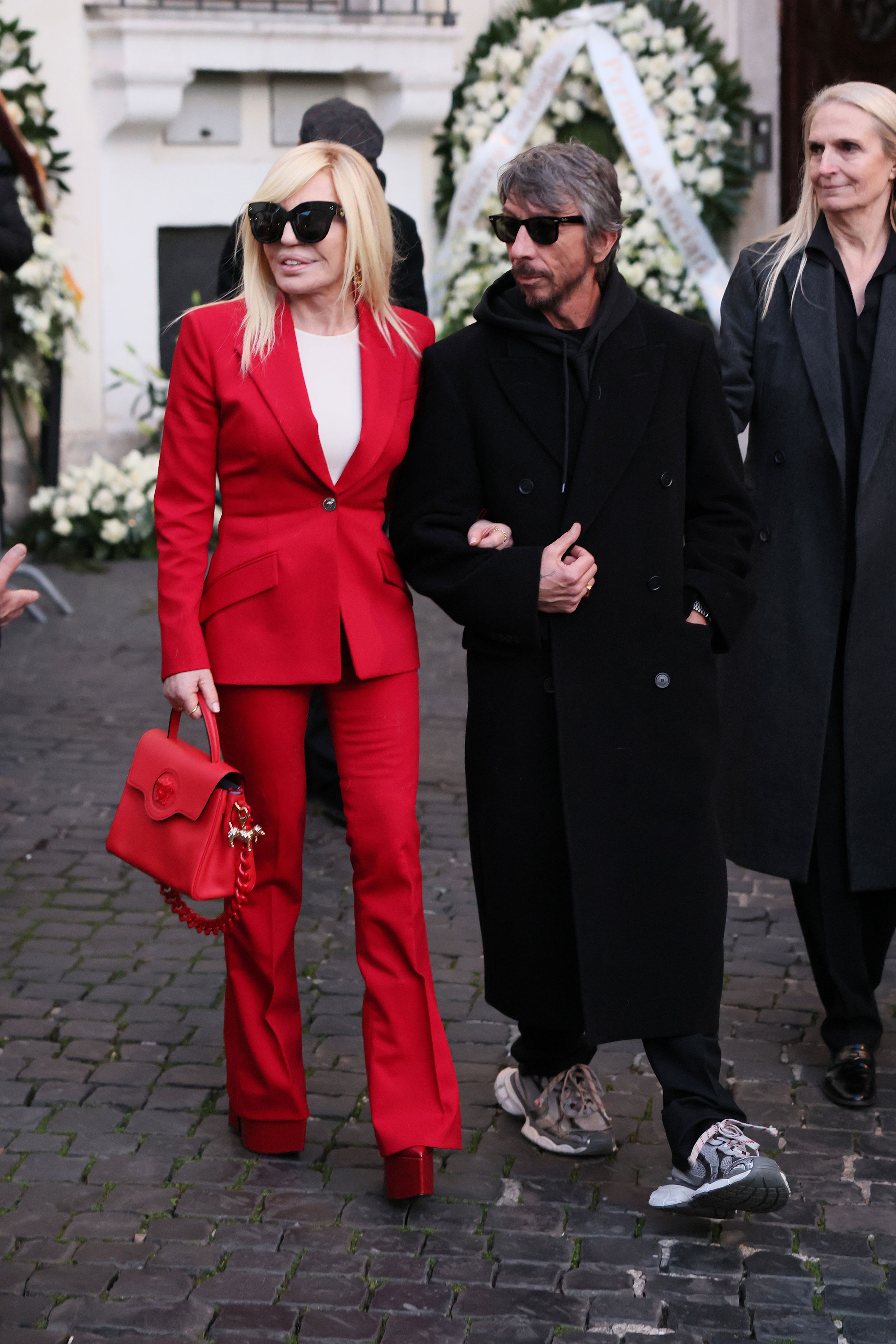 Donatella Versace honors the late Valentino in his signature red hue