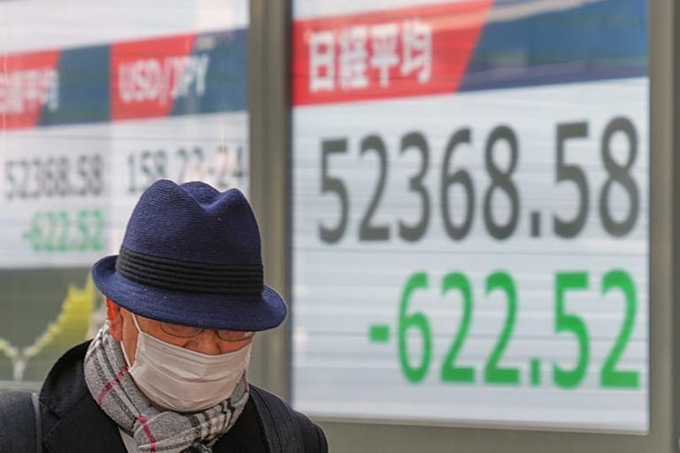 Japan's central bank holds rates steady after bond sell-off and ahead ...