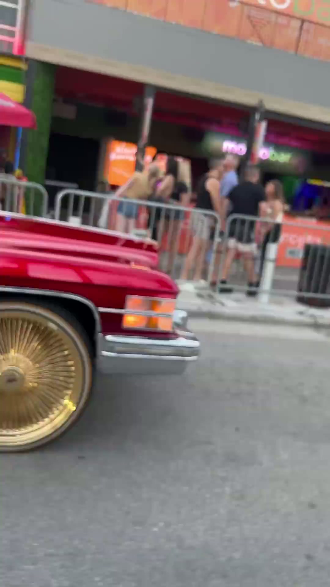 Candy red Cadillac on gold 24’s Daytons riding on the beach