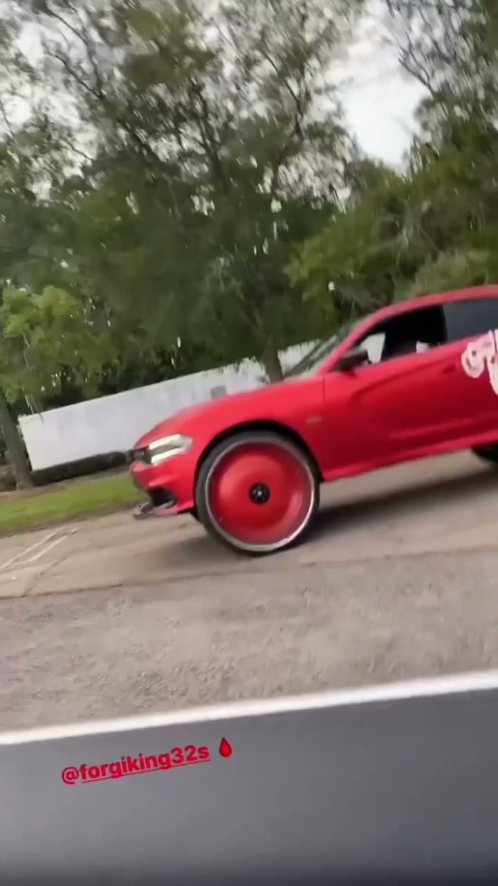 Matte red Scatpack Charger on 32’s DUBS