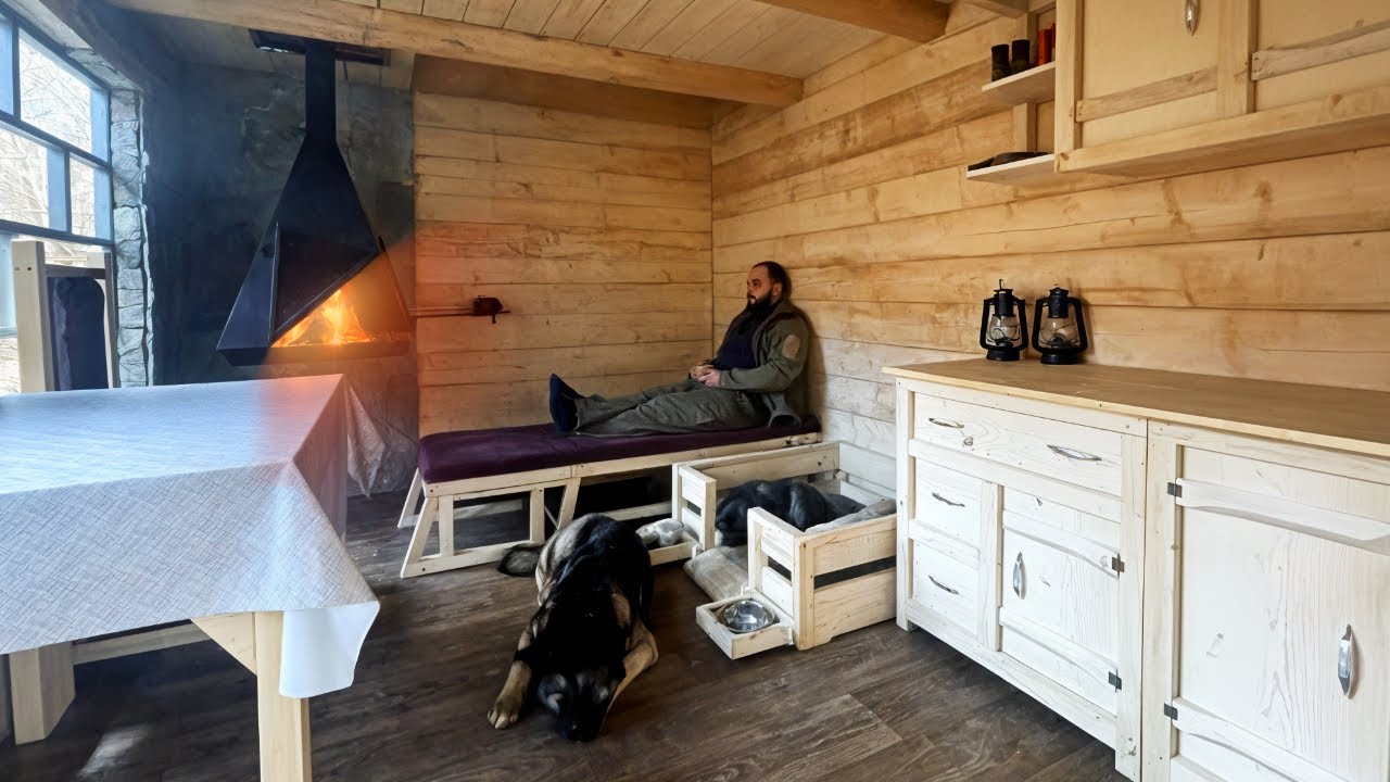 A man built a log house in the forest and lives in it