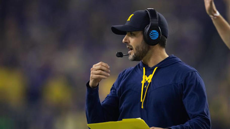 Former Michigan coach punished for cheating against Ohio State gets ...
