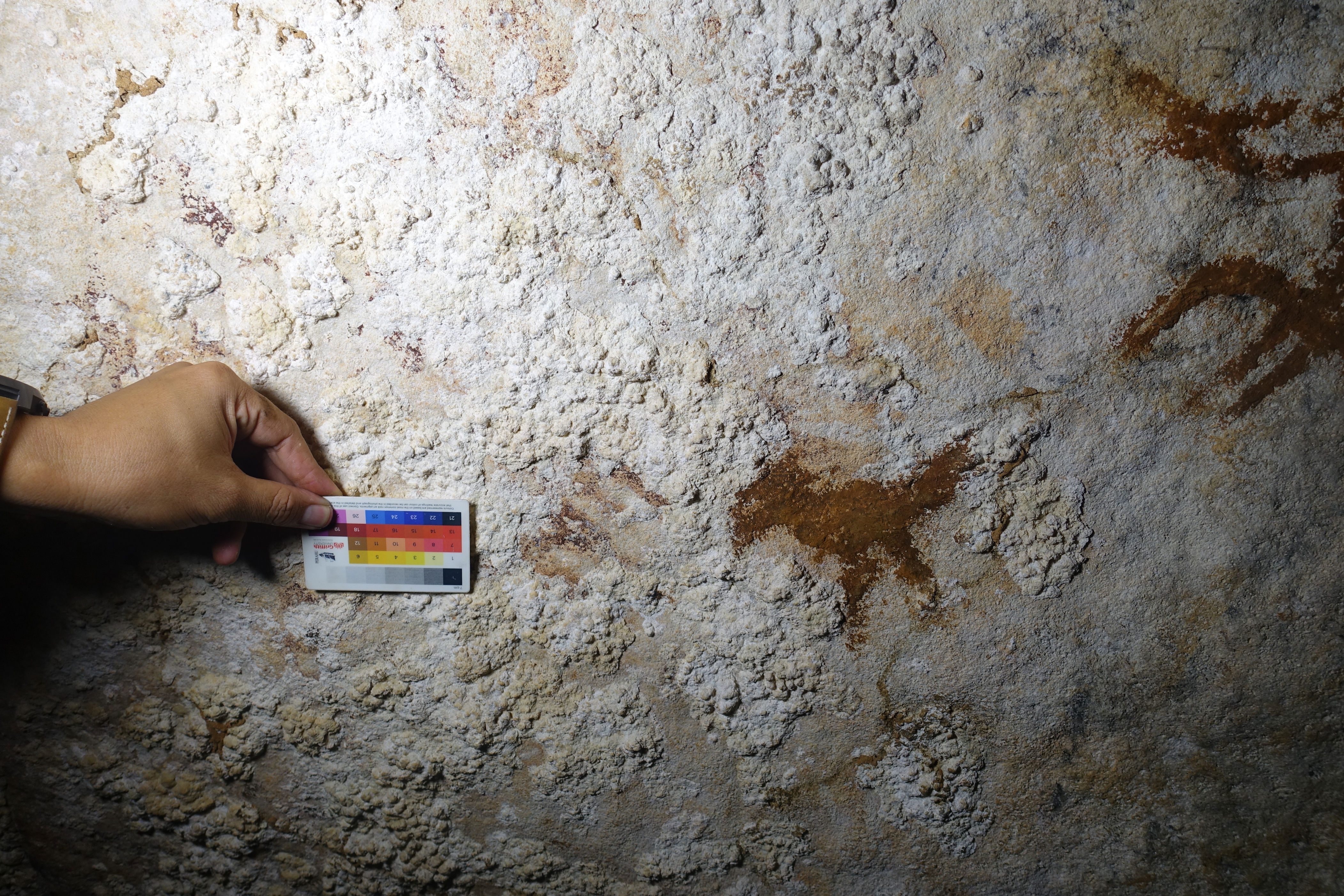 Can you see the faded outline of a hand? Archaeologists say this 67,800 ...