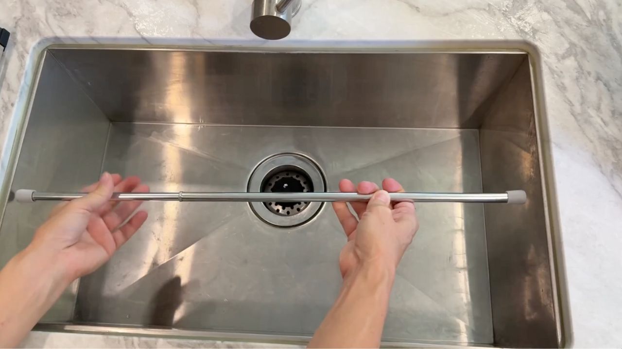 Stick a tension rod in your kitchen sink (this is brilliant!)