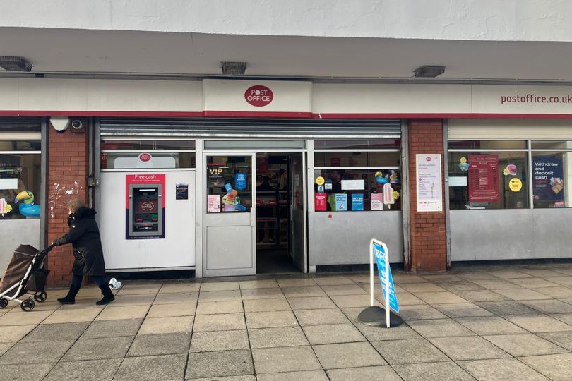 Screams as woman threatened with 'gun' after gang storm post office