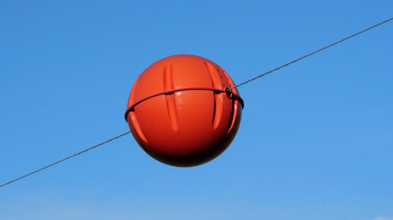 Why do power lines have orange balls on them?