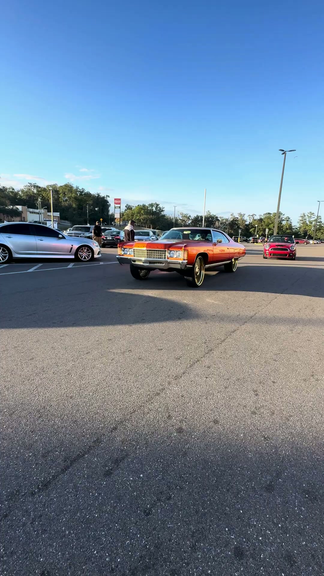 Candy tangerine Chevy fastback on 26's