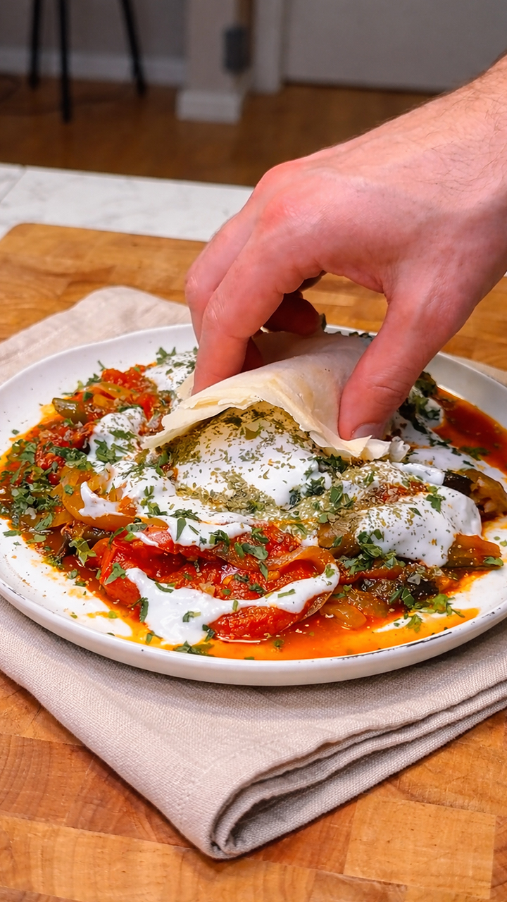 Making vegan borani banjan with yogurt and tomato