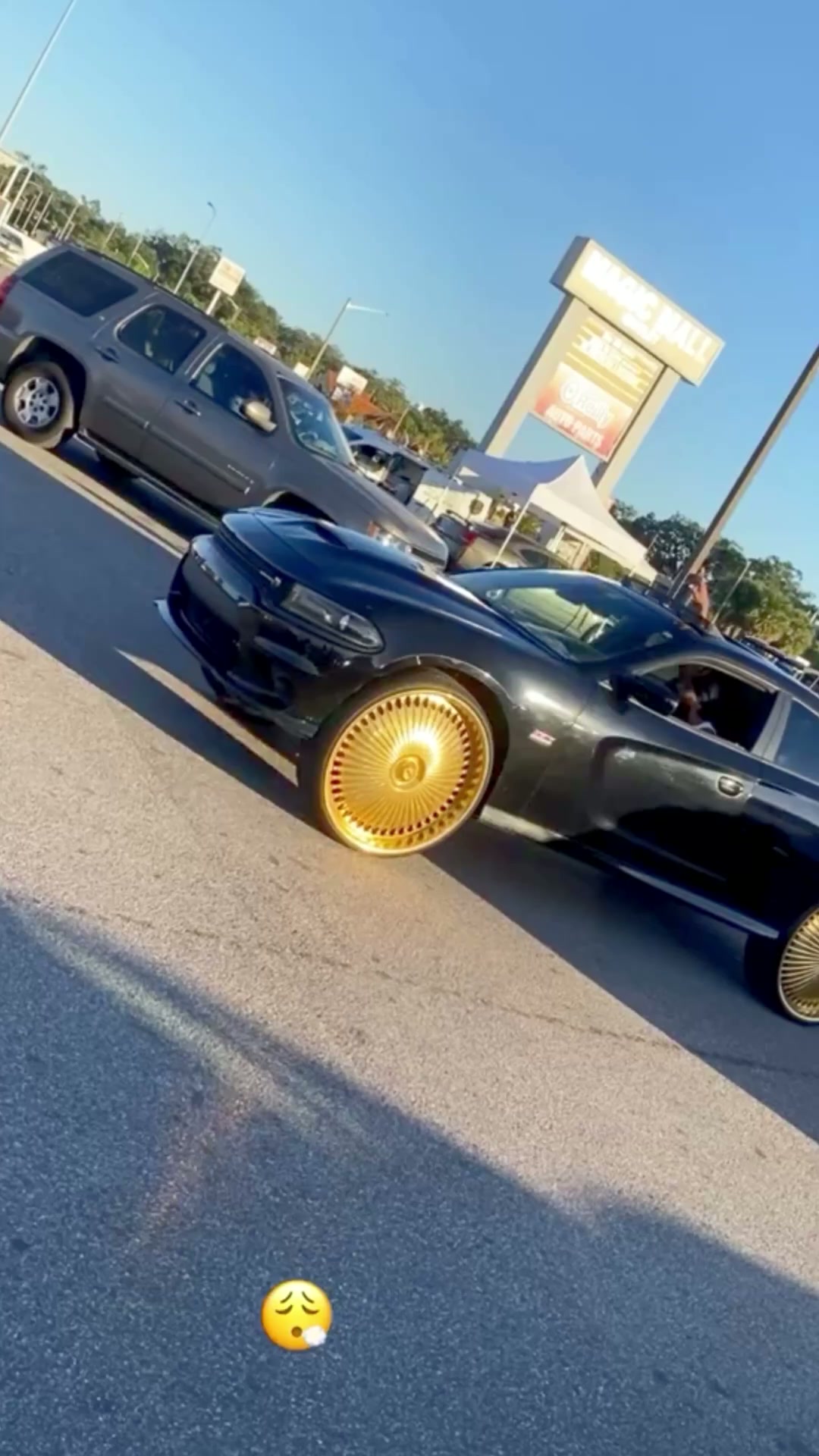 Black Dodge Charger and Dodge Ram 1500 on gold 30” DUB floaters