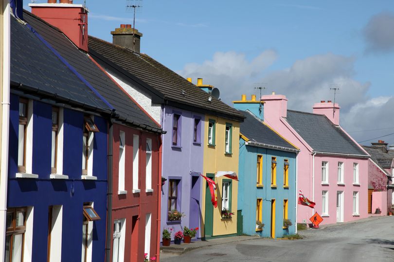 Quaint Irish village with vibrant multi-coloured houses and beautiful bay