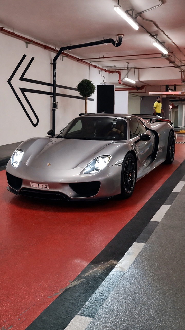 Silver Porsche 918 glides through indoor space
