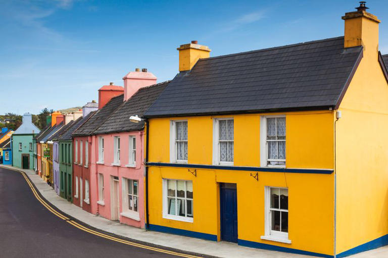 Quaint Irish village with vibrant multi-coloured houses and beautiful bay
