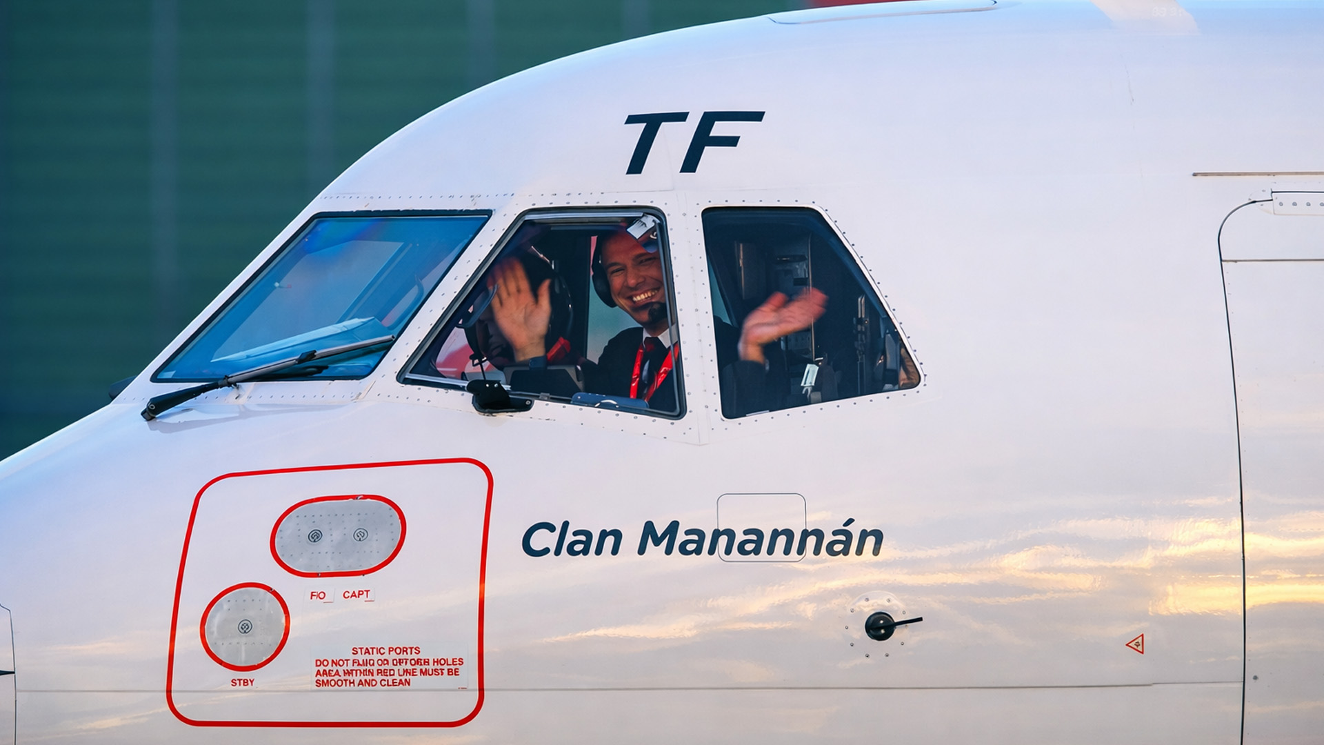 Smiling pilot waves to plane spotters