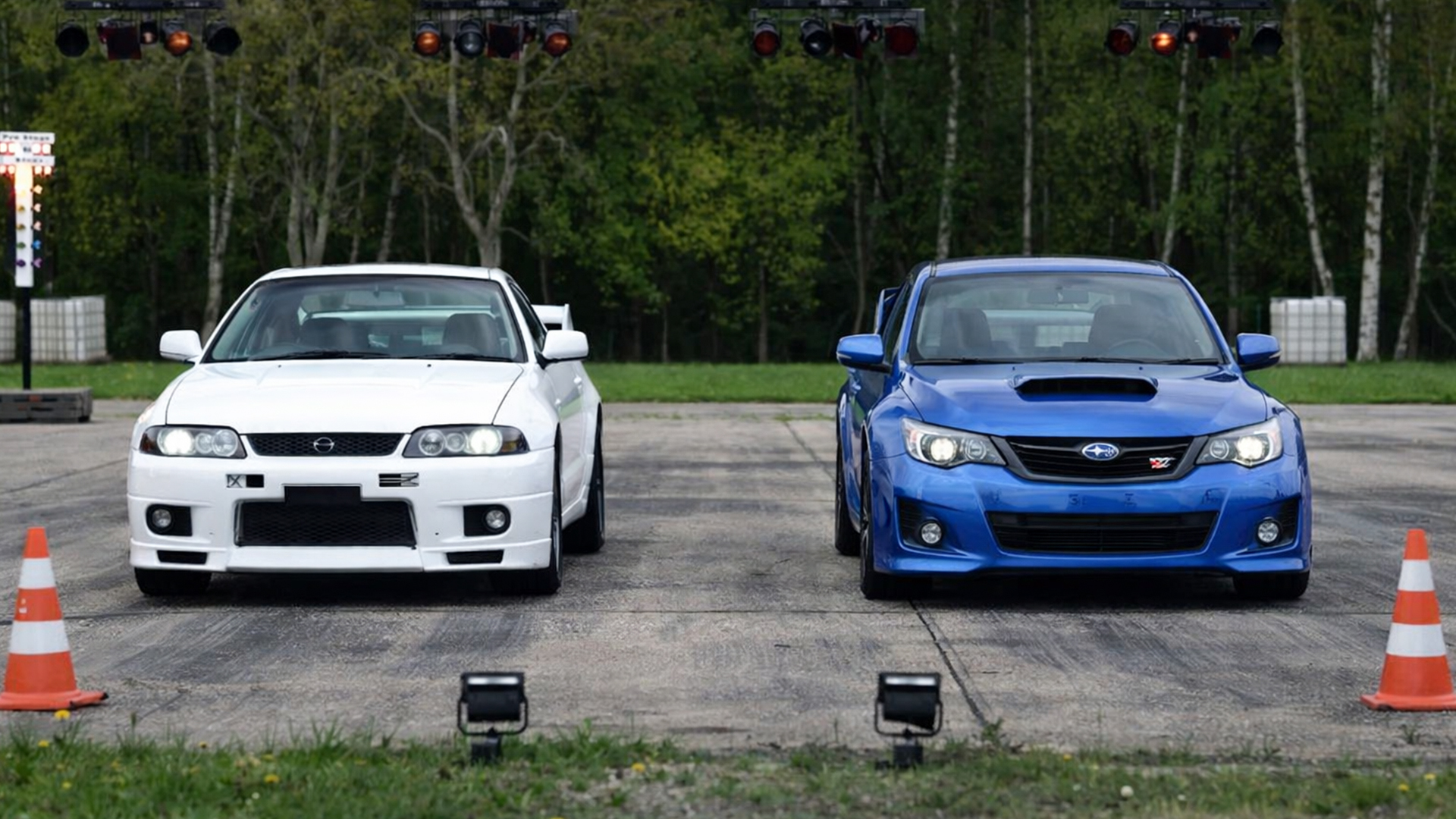 Drag race action with Subaru and Nissan cars