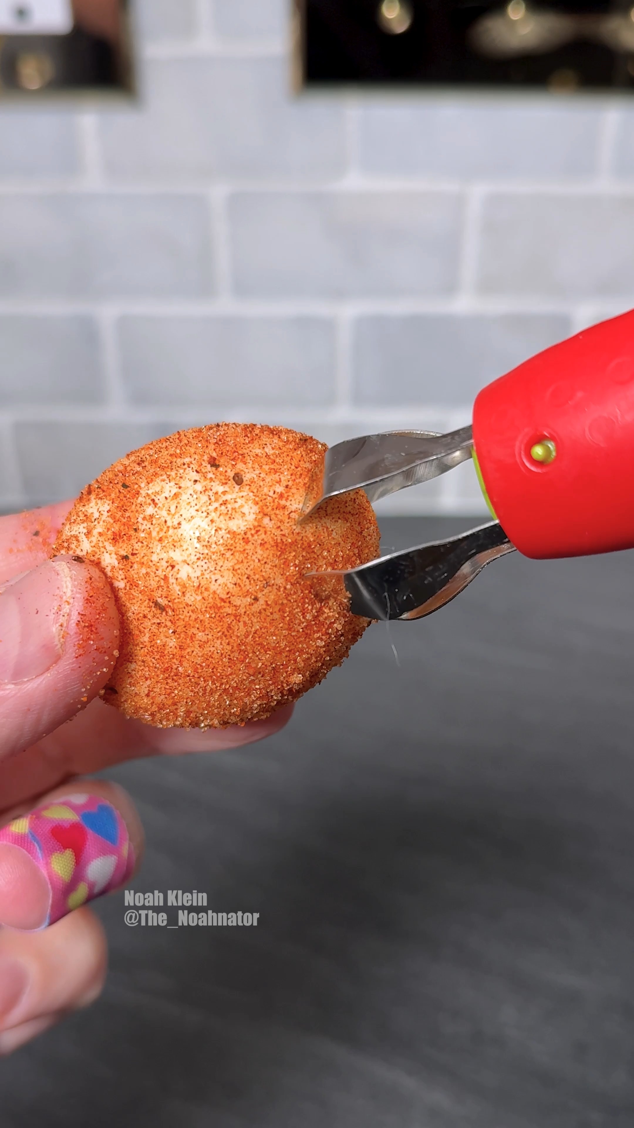 Red bird egg tested with a huller