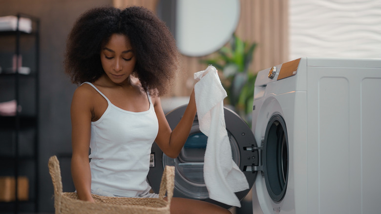 What happens if you add a dry towel to a dryer full of wet clothes?