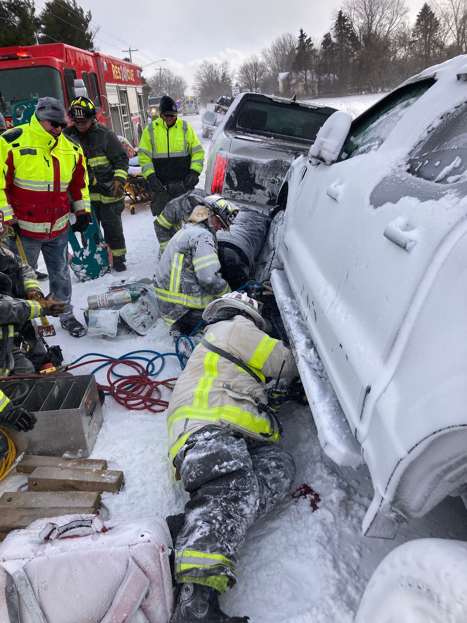 Whiteout conditions lead to chain-reaction crash, man pinned between cars