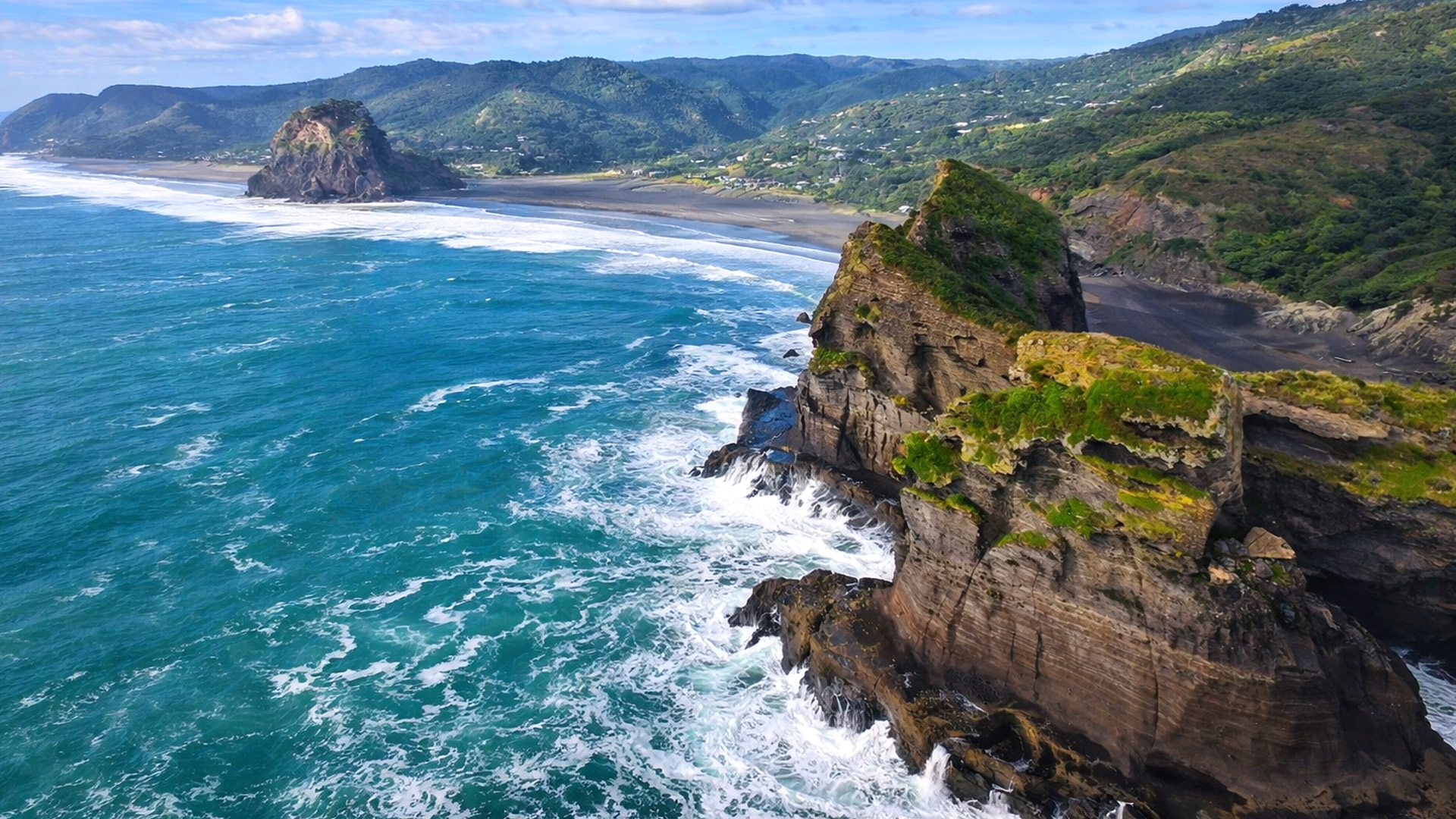 The rugged coastline of Piha Beach