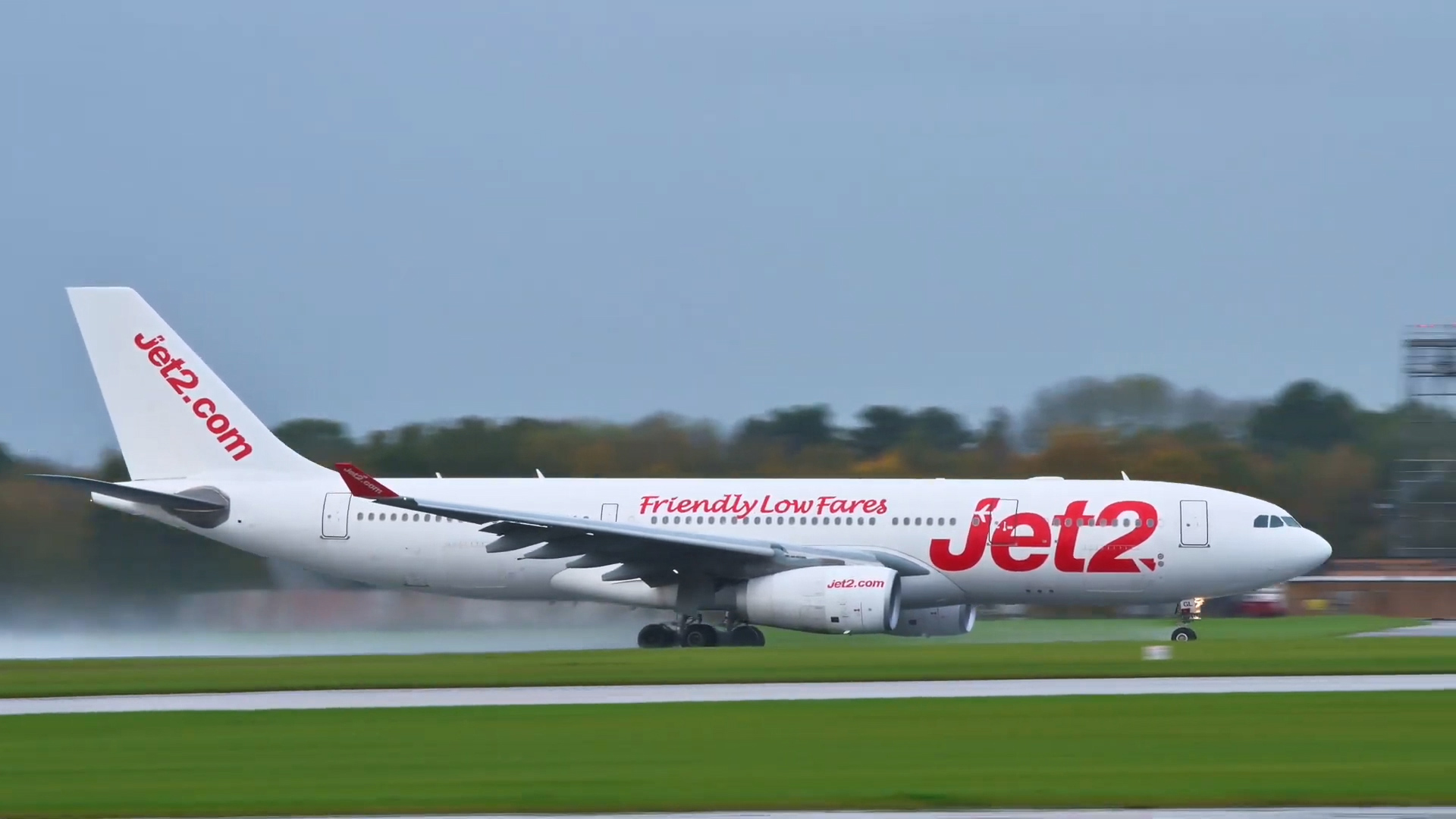 Passenger planes take off from wet runways