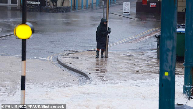 Moment girl is nearly swept out to sea taking a selfie on a harbour ...