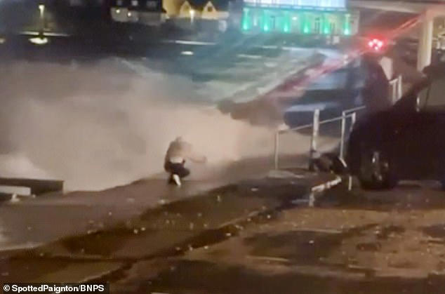 Moment girl is nearly swept out to sea taking a selfie on a harbour ...