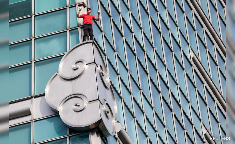 US climber scales Taiwan's tallest building without ropes in 91 minutes