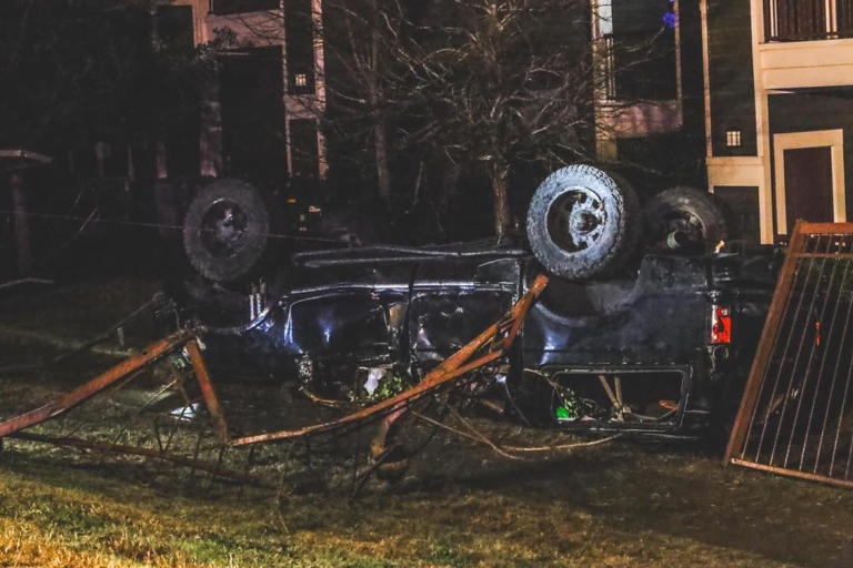 Driver hospitalized after rollover and crash into apartment building