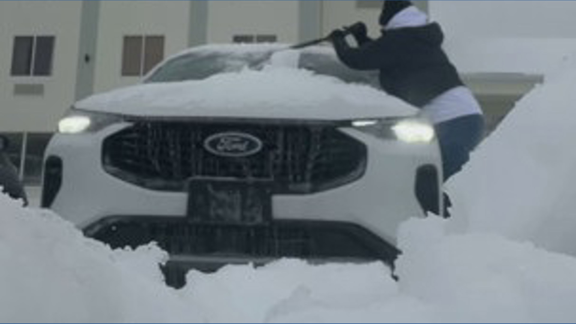 Elizabethtown crew scrap a layer of ice from car