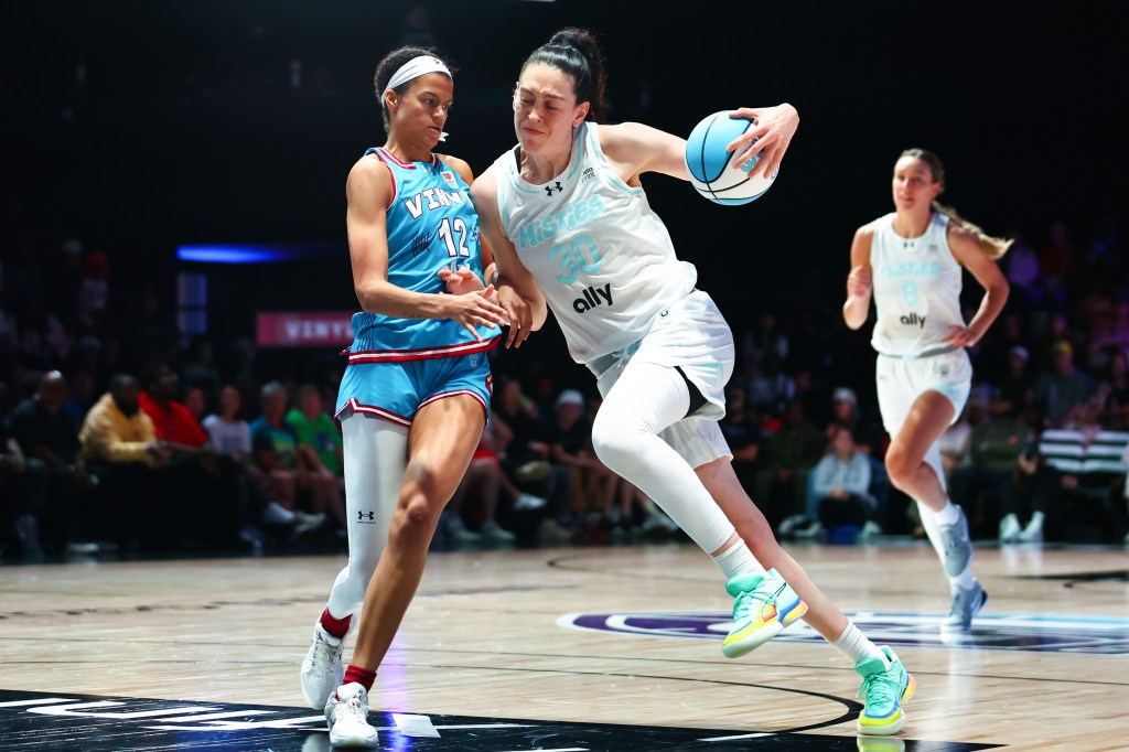 Liberty star Breanna Stewart holds 'abolish ICE' sign before Unrivaled game