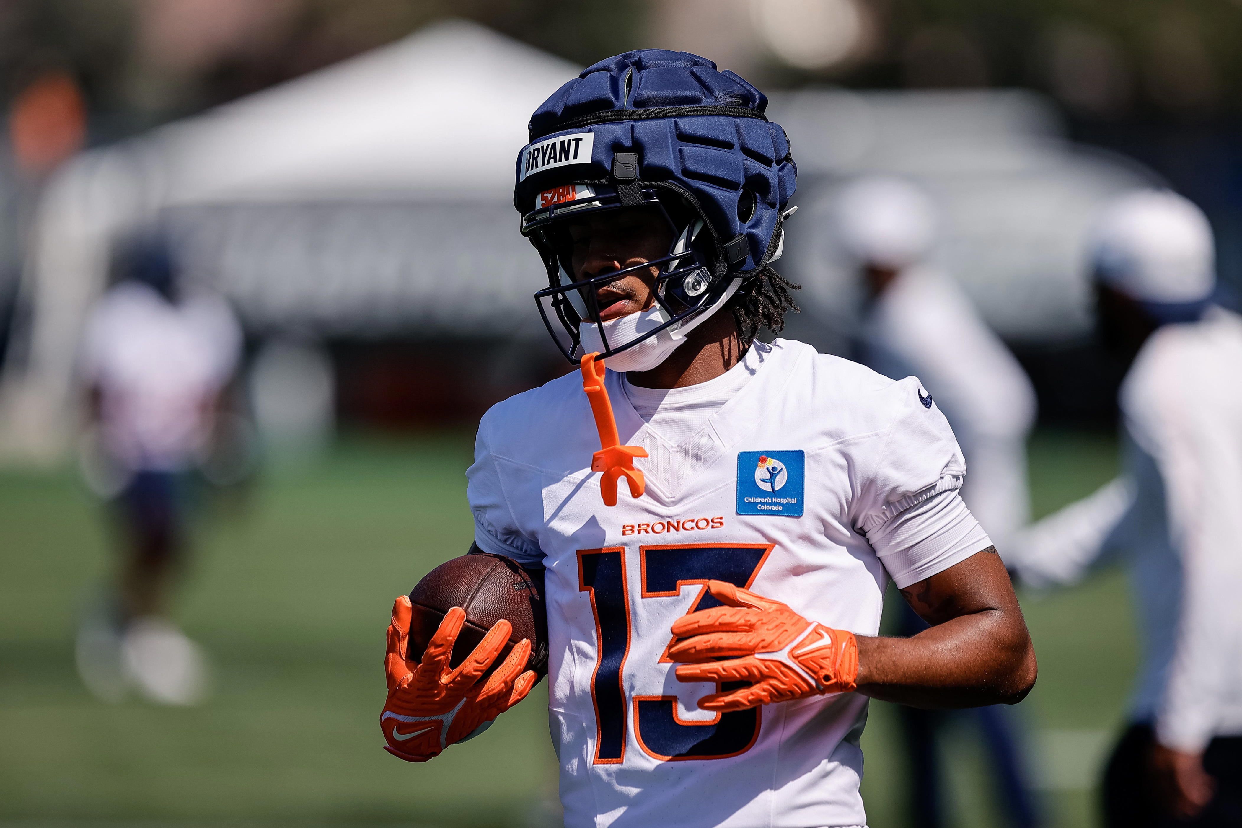 Why Broncos WR Pat Bryant is wearing a Guardian Cap on helmet vs. Patriots