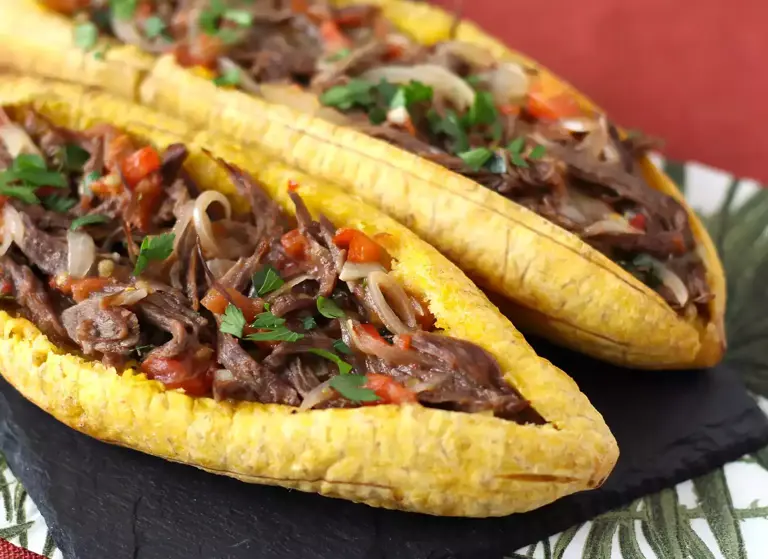 Plantains stuffed with shredded meat and grated cheese