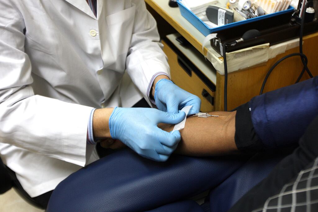 Can an employer reduce medical insurance benefits for staff in the UAE?