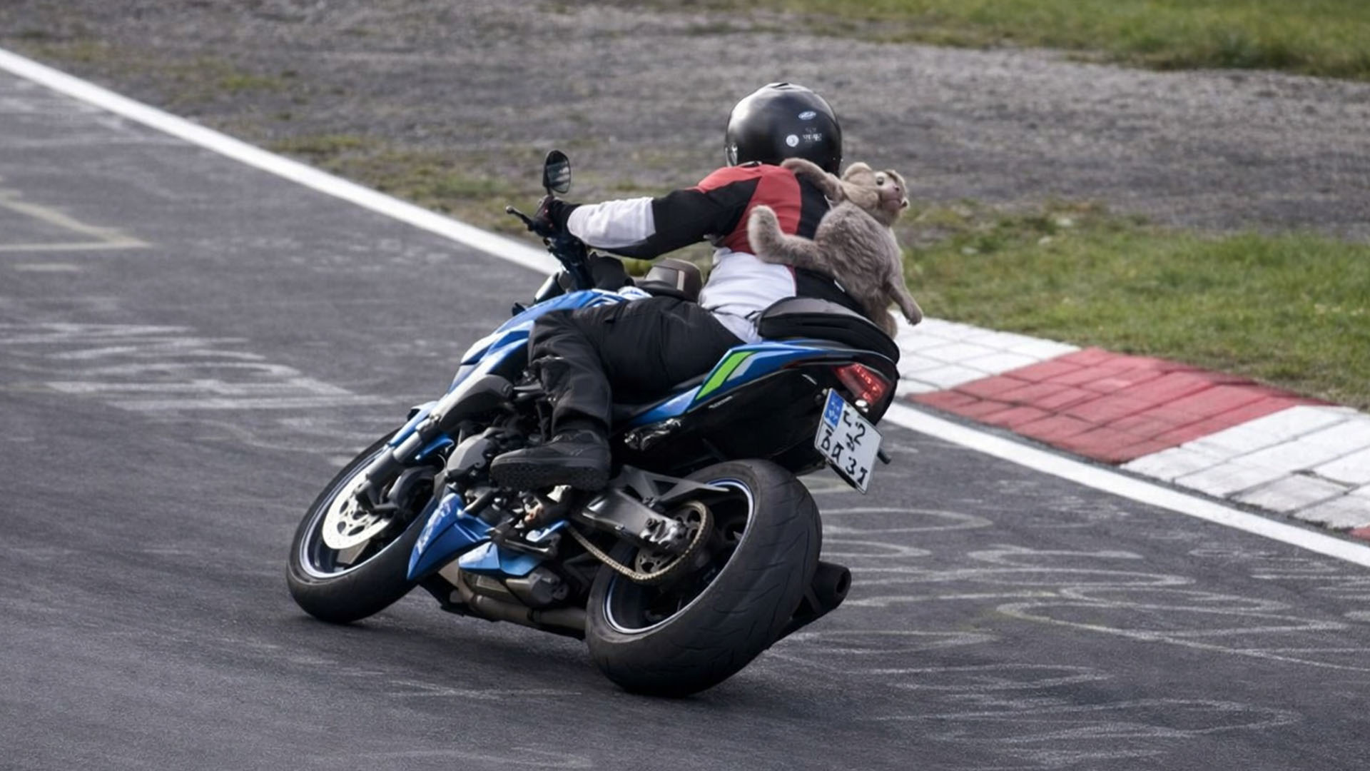 Motorbike rider seen carrying doll at Brünnchen