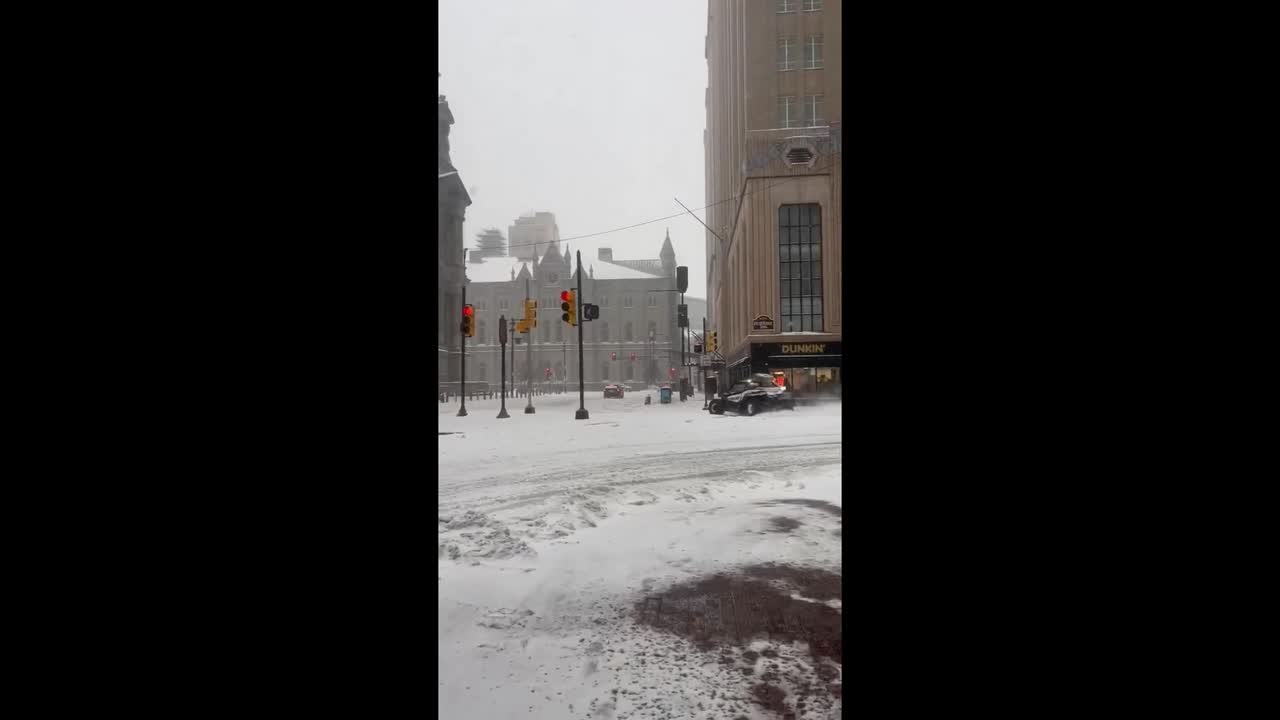 Snowy City Hall turns into playful scene as mini-buggy spins through ...