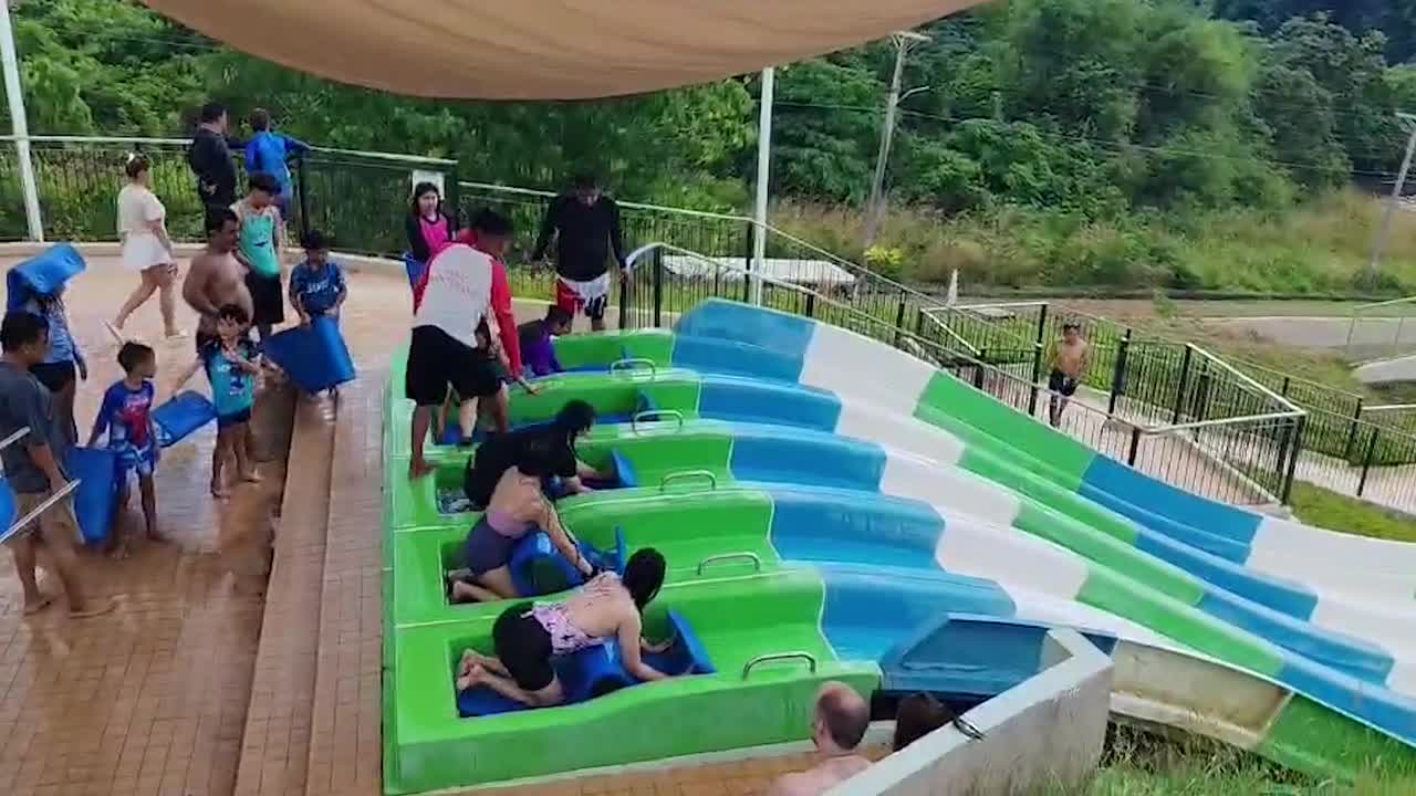 Tourists fail to move and need a push down water slide